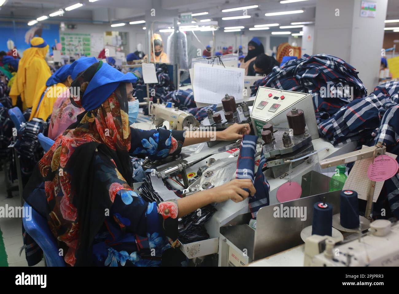 Garment workers work at a ready-made garment factory in Bangladesh ...
