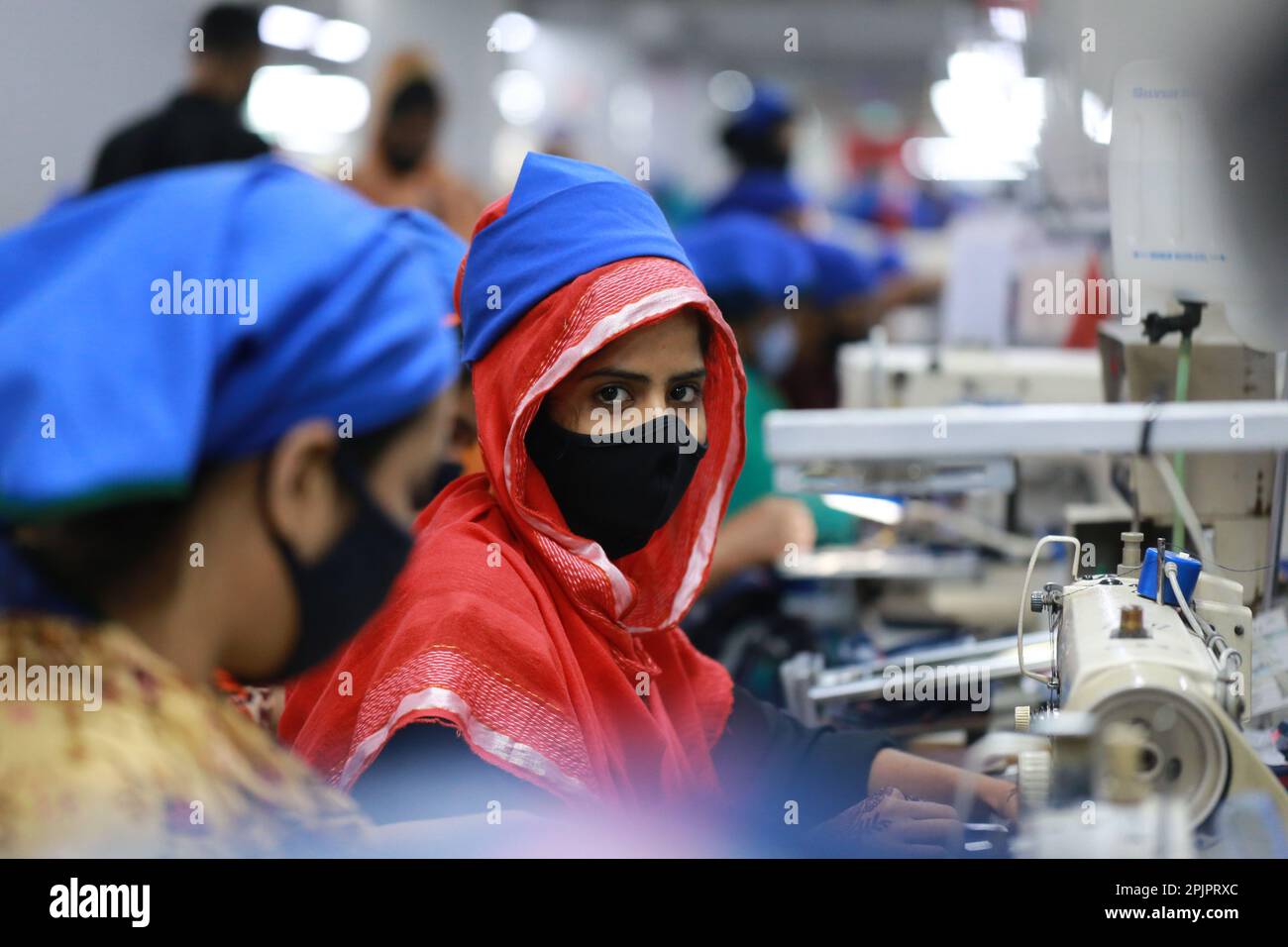 Garment workers work at a ready-made garment factory in Bangladesh ...