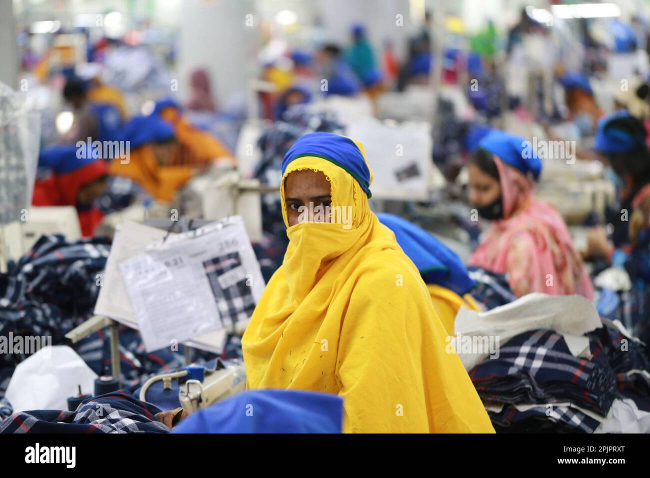 Garment workers work at a ready-made garment factory in Bangladesh ...