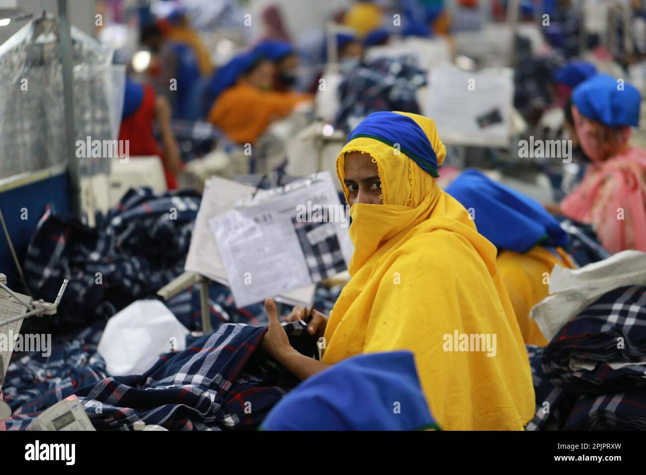 Garment workers work at a ready-made garment factory in Bangladesh ...