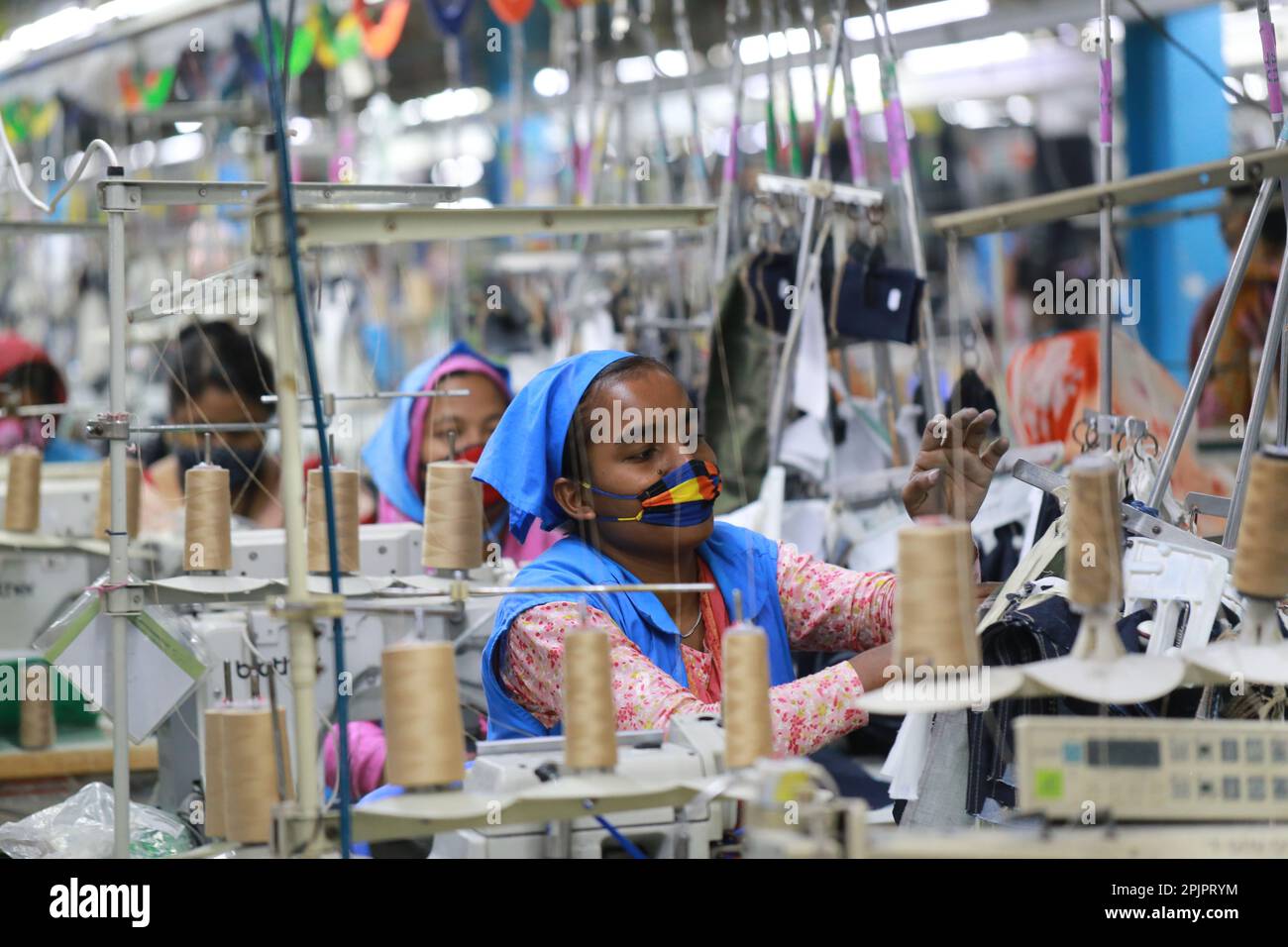 Garment workers work at a ready-made garment factory in Bangladesh ...