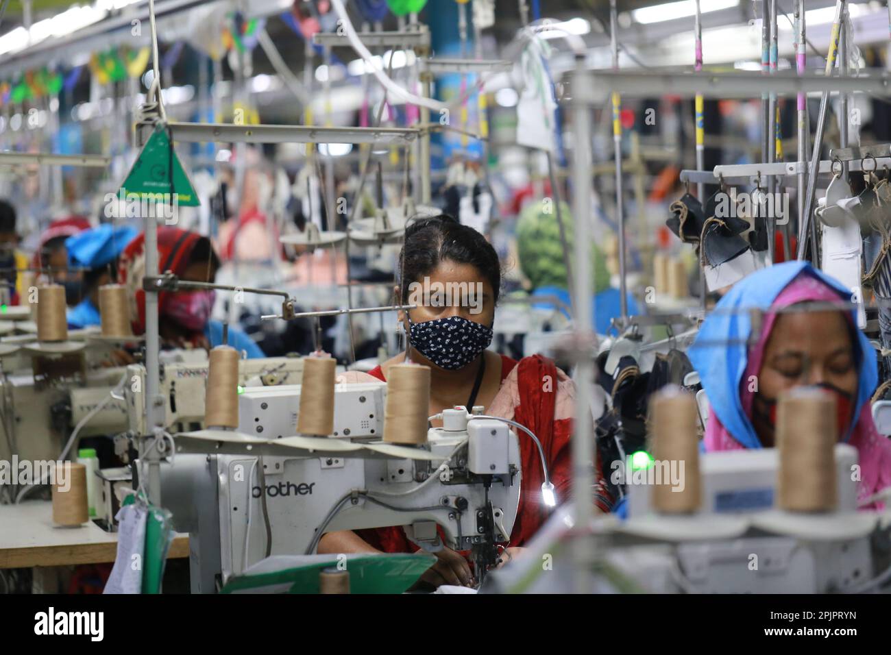 Garment workers work at a ready-made garment factory in Bangladesh ...