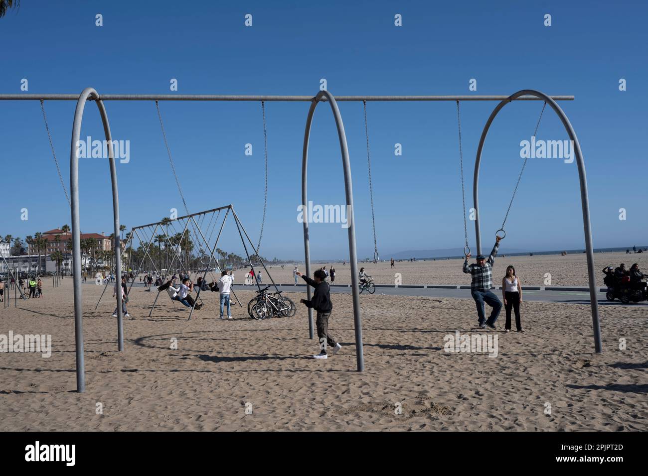 Santa Monica, California, USA. 26th Mar, 2023. Beachgoers swing on ...