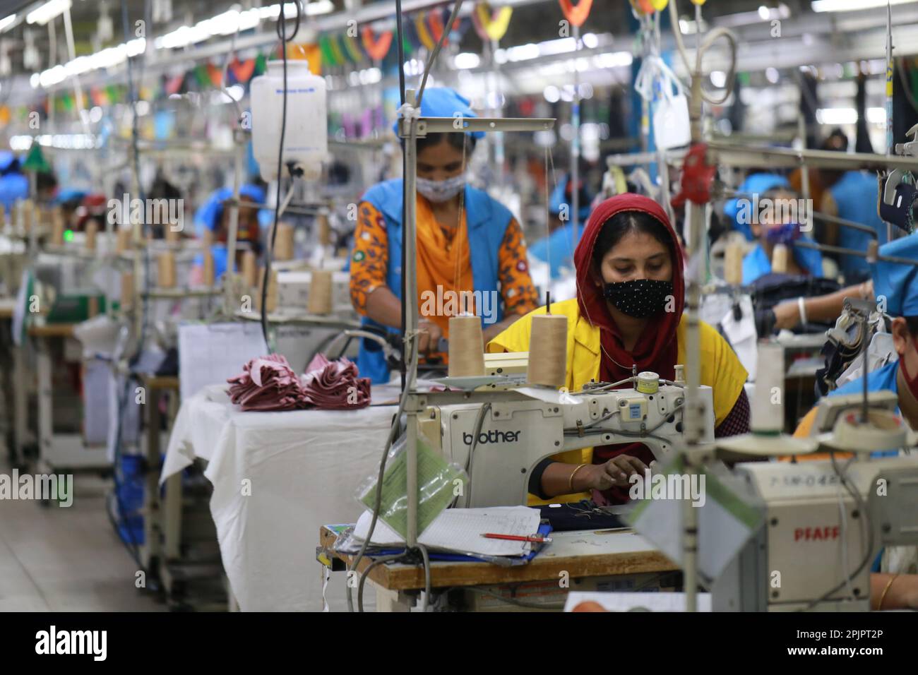 Garment workers work at a ready-made garment factory in Bangladesh Stock Photo - Alamy