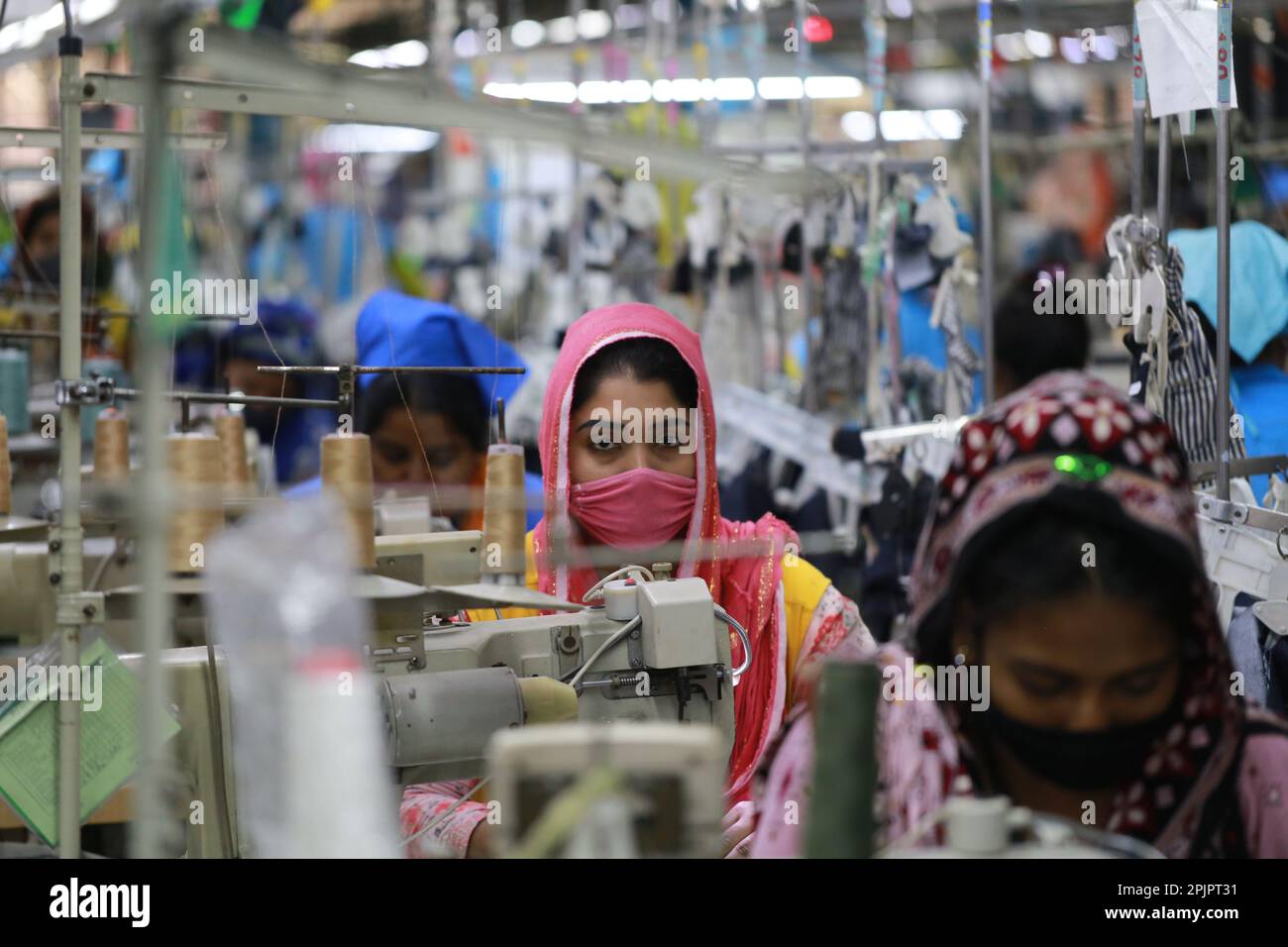 Garment workers work at a ready-made garment factory in Bangladesh ...