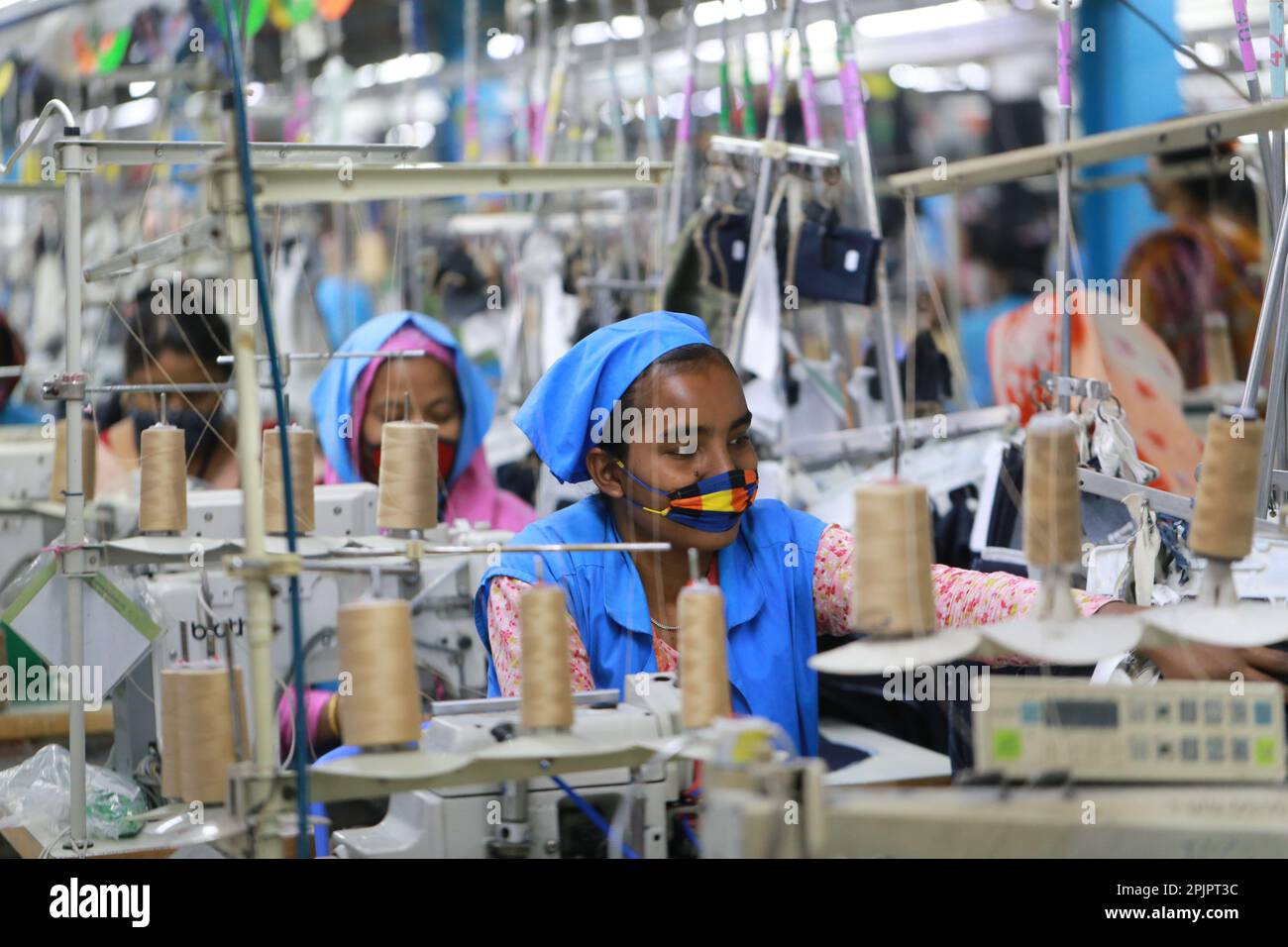 Garment workers work at a ready-made garment factory in Bangladesh ...