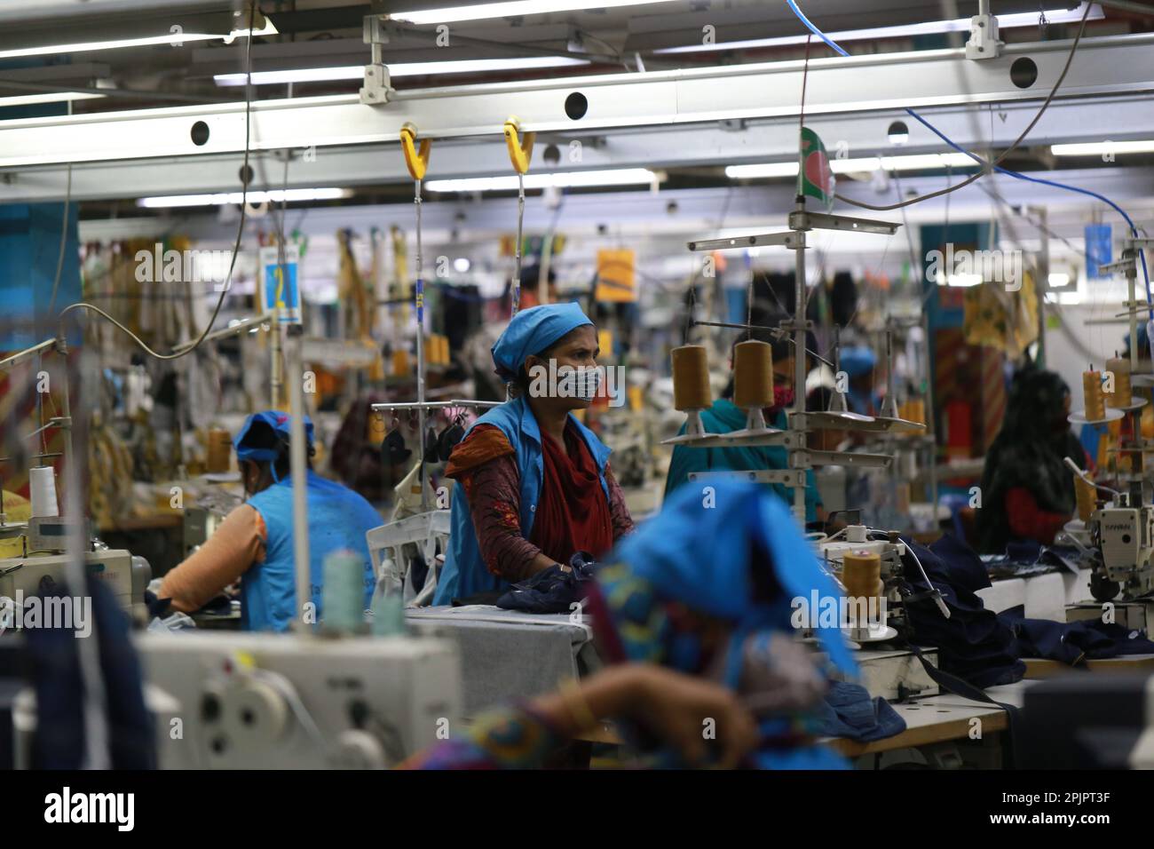Garment workers work at a ready-made garment factory in Bangladesh ...