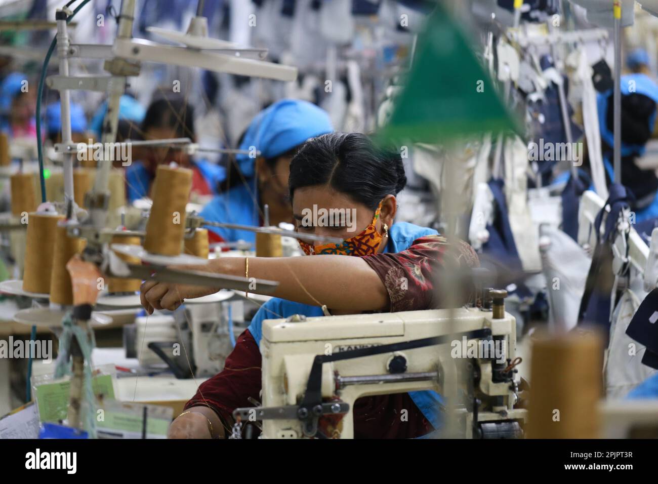 Garment workers work at a ready-made garment factory in Bangladesh ...