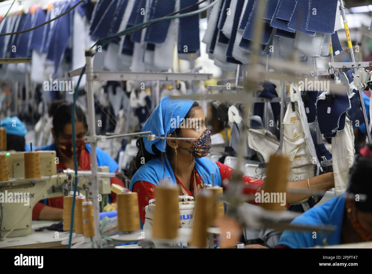 Garment workers work at a ready-made garment factory in Bangladesh ...