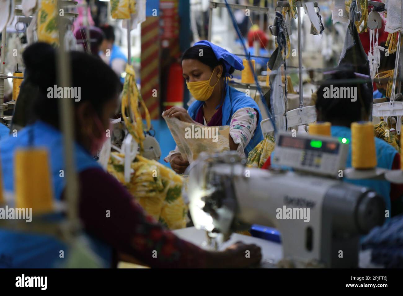 Garment workers work at a ready-made garment factory in Bangladesh ...