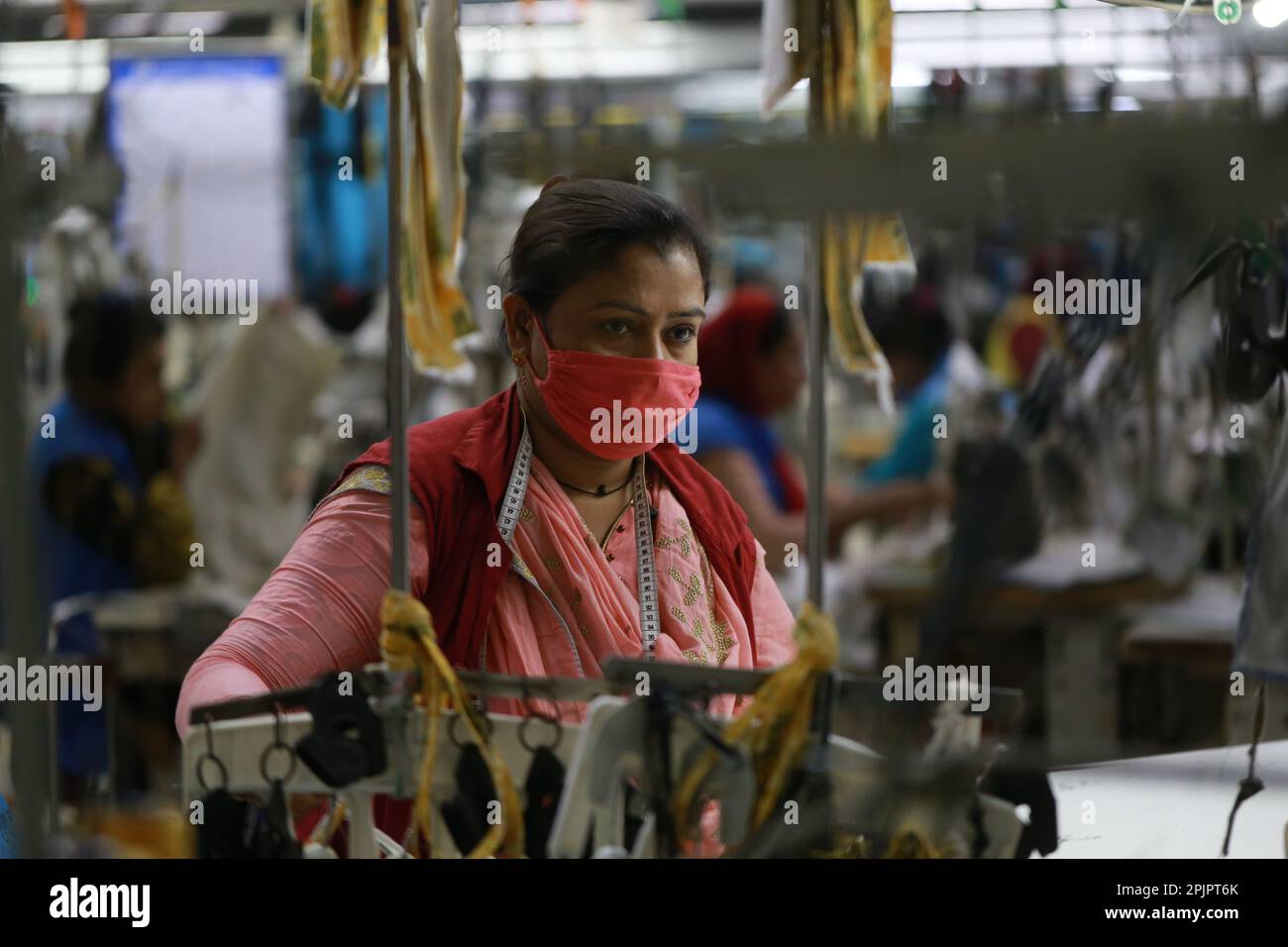 Garment workers work at a ready-made garment factory in Bangladesh ...