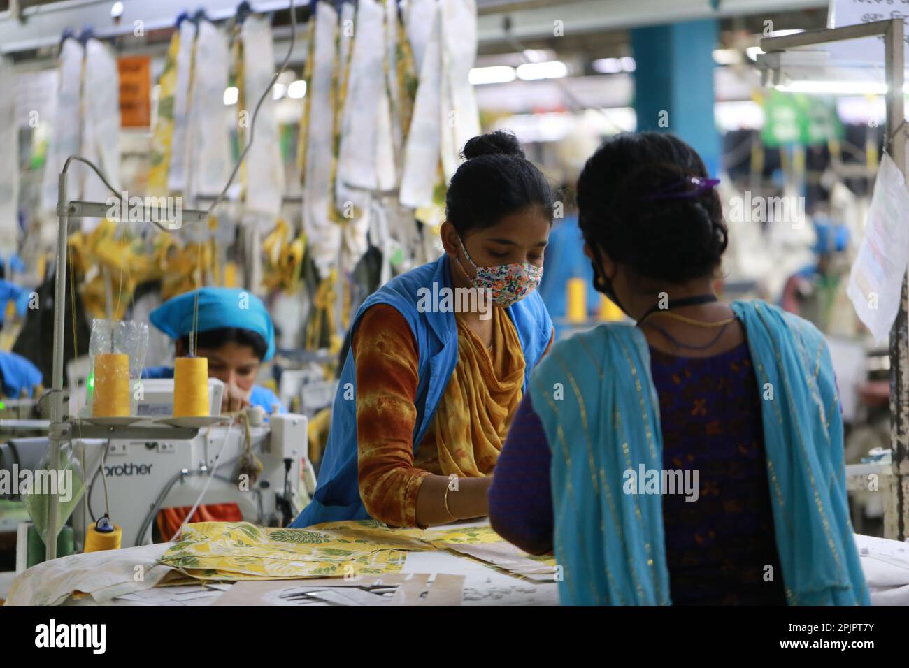 Garment workers work at a ready-made garment factory in Bangladesh ...