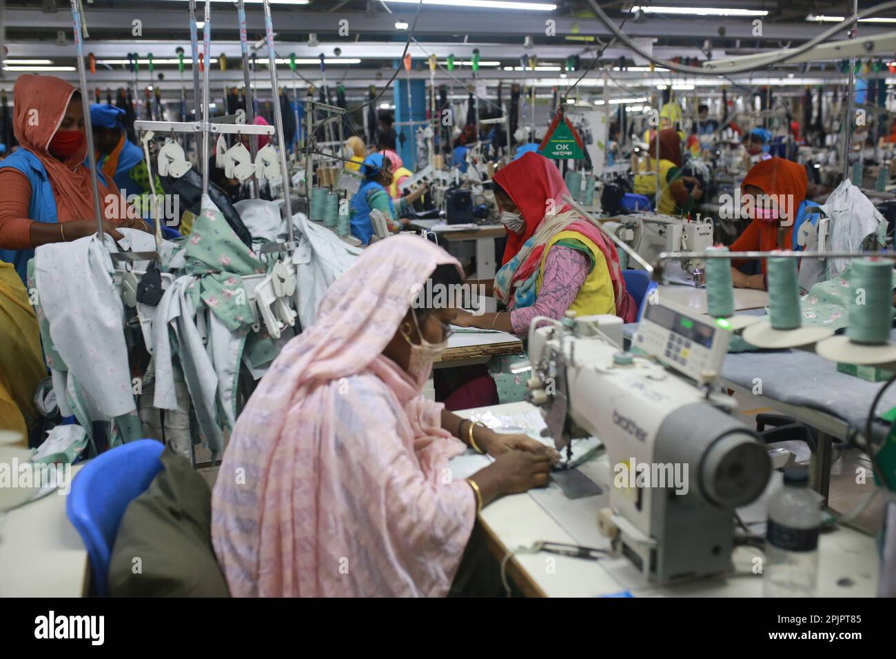 Garment workers work at a ready-made garment factory in Bangladesh ...