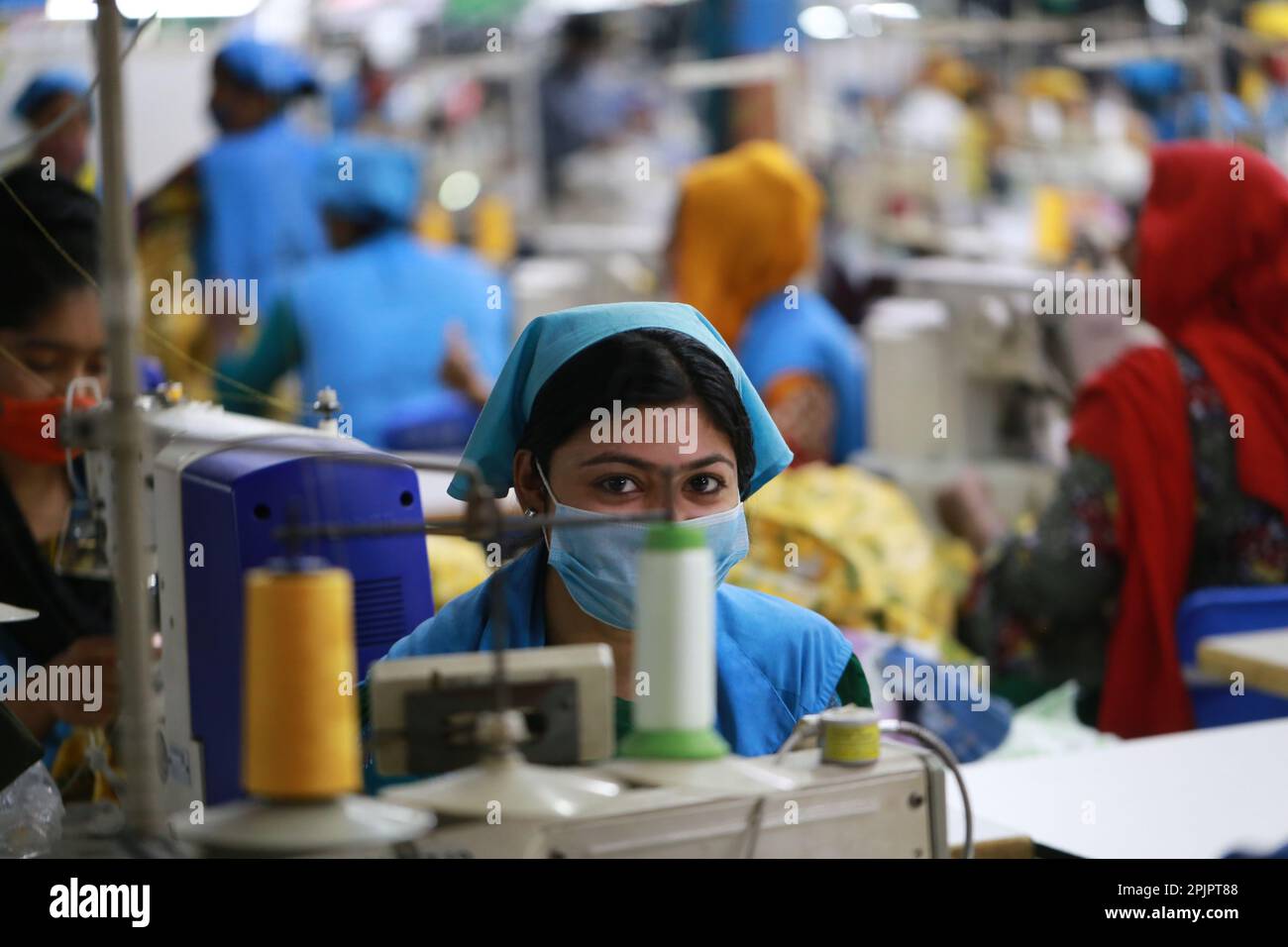 Garment workers work at a ready-made garment factory in Bangladesh ...