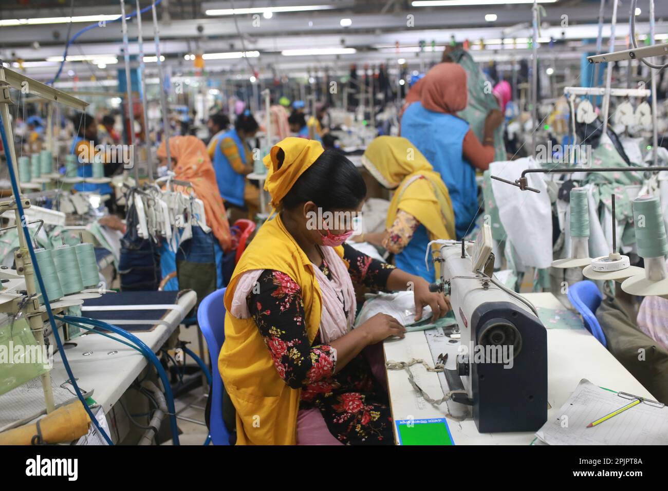 Garment workers work at a ready-made garment factory in Bangladesh ...