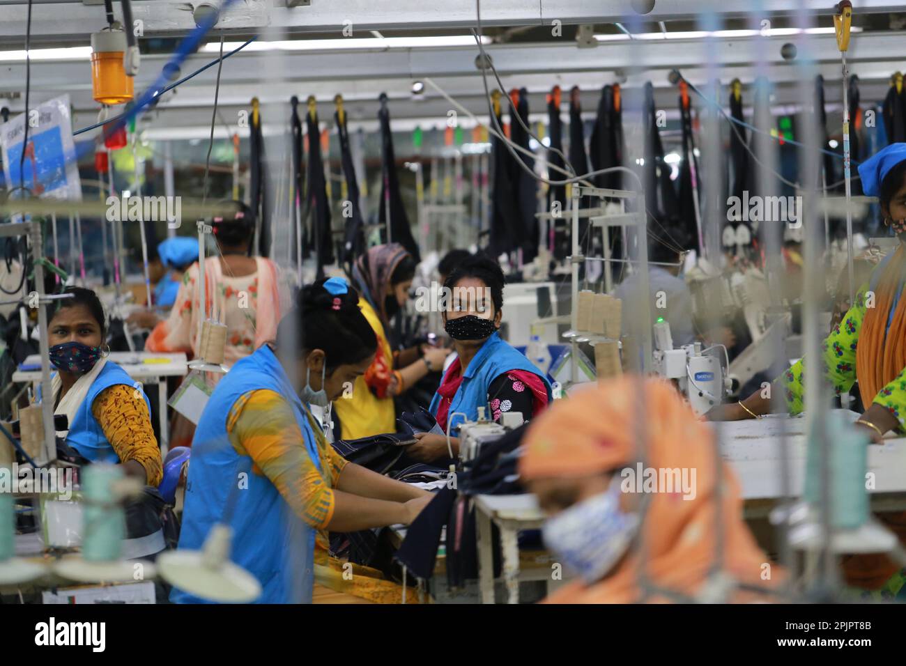 Garment workers work at a ready-made garment factory in Bangladesh ...