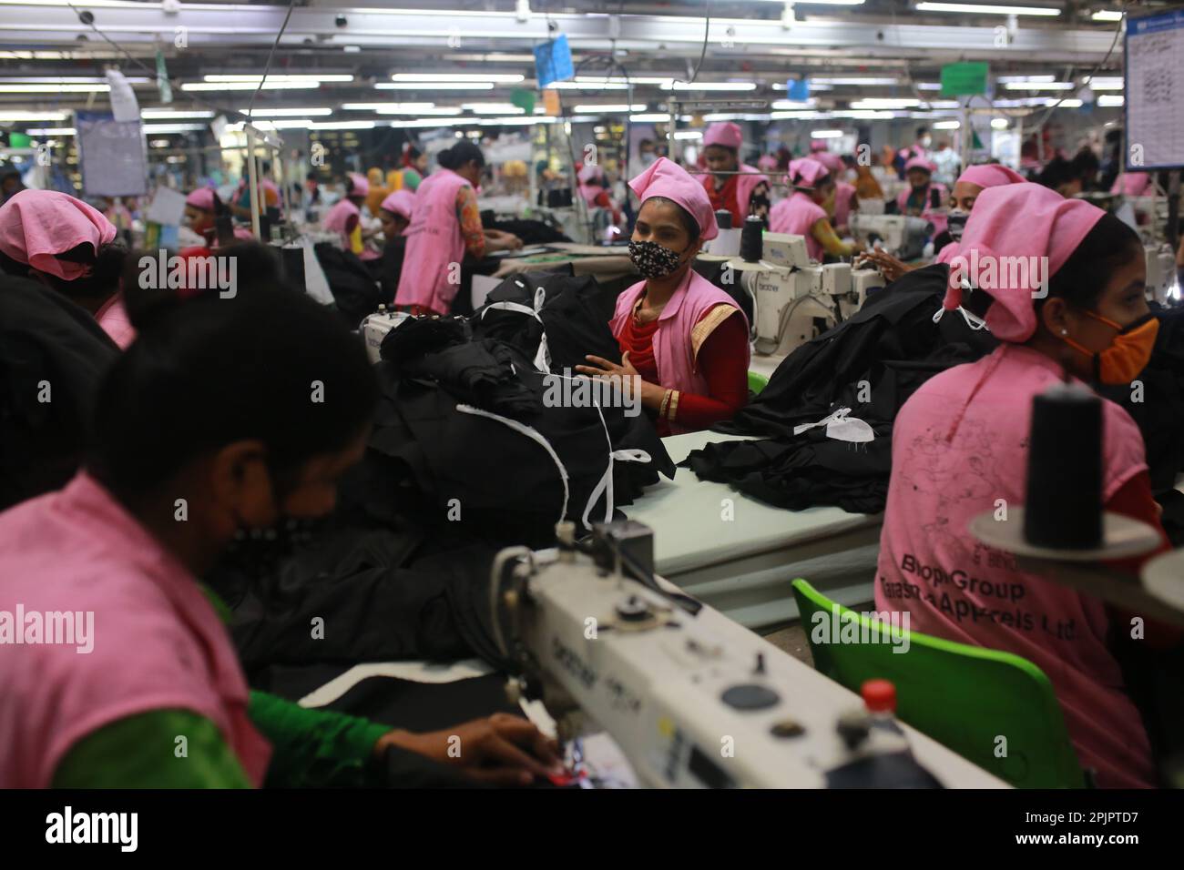 Garment workers work at a ready-made garment factory in Bangladesh ...