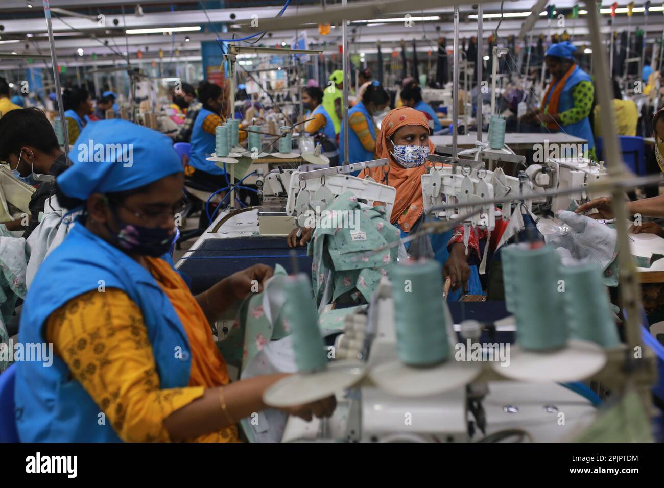 Garment workers work at a ready-made garment factory in Bangladesh ...