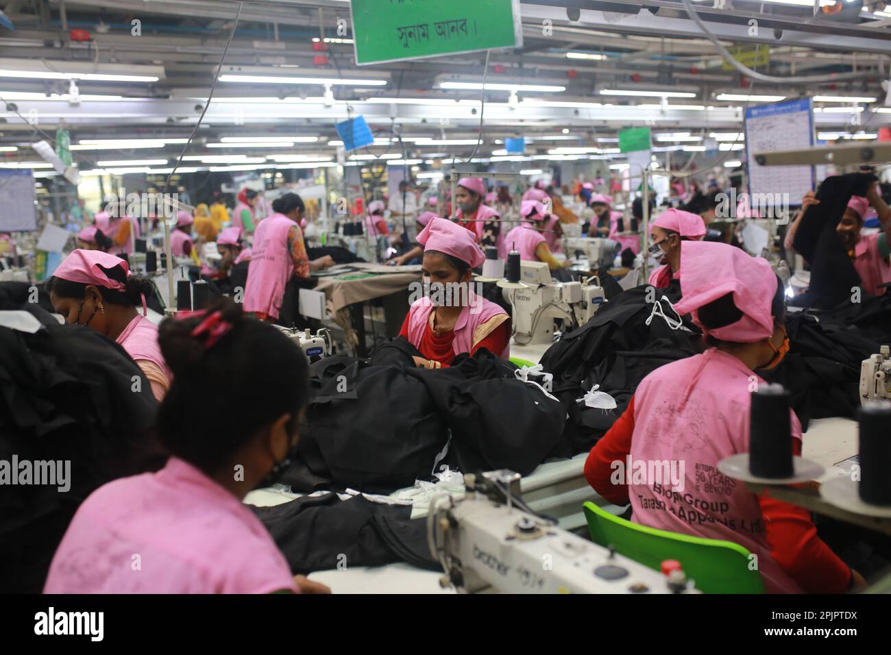 Garment workers work at a ready-made garment factory in Bangladesh ...