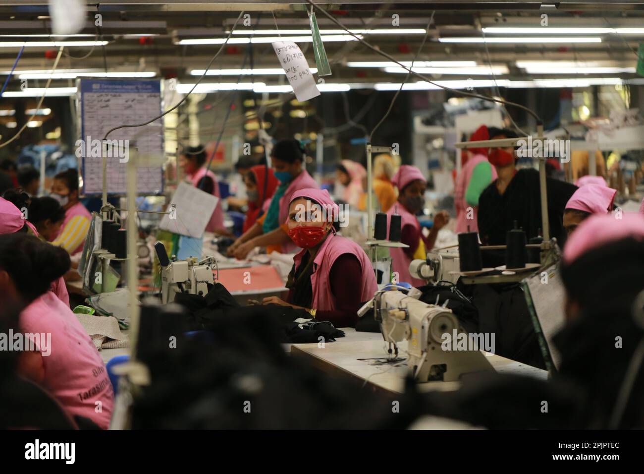 Garment workers work at a ready-made garment factory in Bangladesh ...