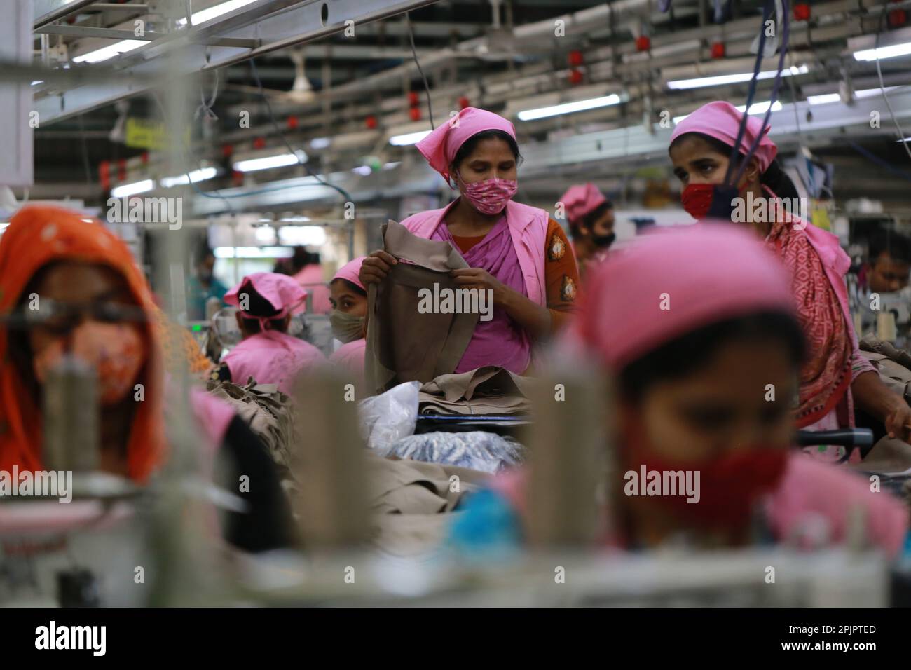 Garment workers work at a ready-made garment factory in Bangladesh ...
