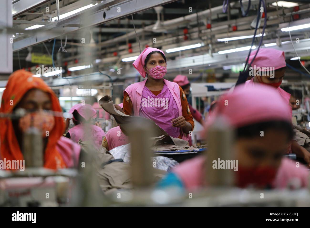 Garment workers work at a ready-made garment factory in Bangladesh ...
