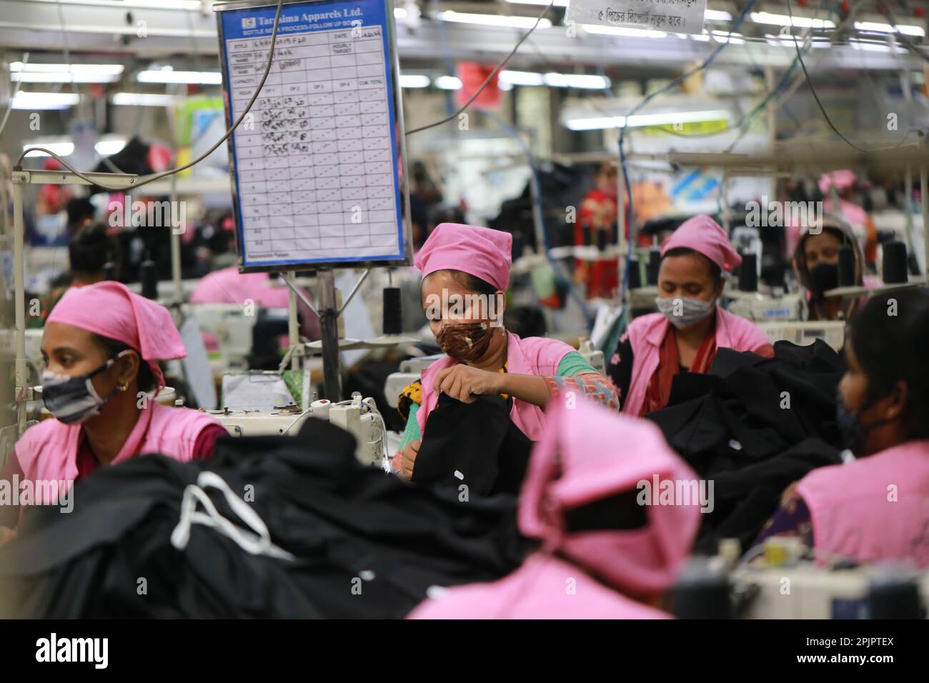 Garment workers work at a ready-made garment factory in Bangladesh ...