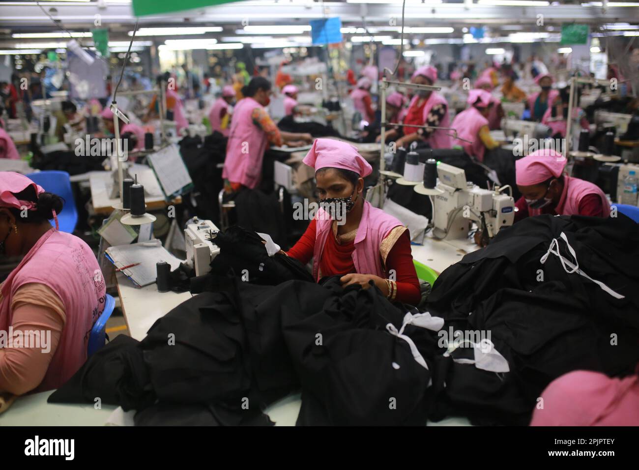 Garment workers work at a ready-made garment factory in Bangladesh ...
