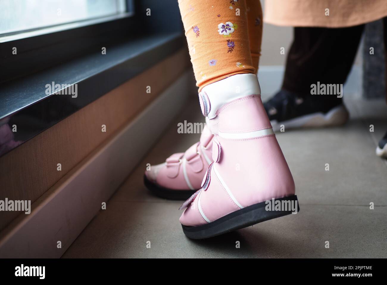 Child cerebral palsy disability, legs orthosis Stock Photo - Alamy