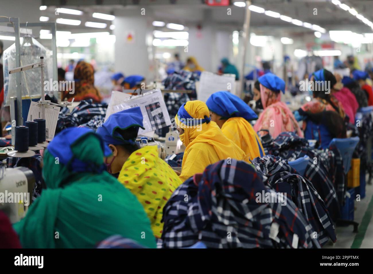 Garment workers work at a ready-made garment factory in Bangladesh ...