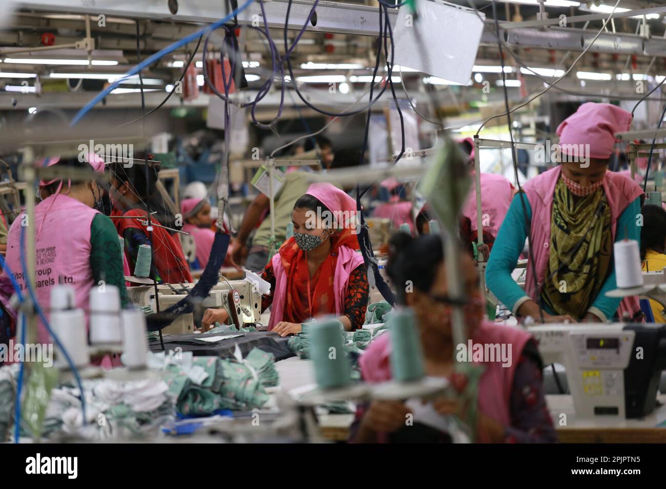 Garment workers work at a ready-made garment factory in Bangladesh ...