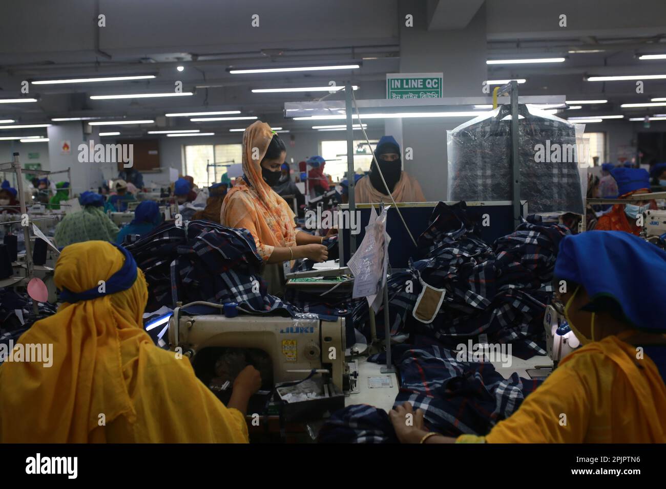 Garment workers work at a ready-made garment factory in Bangladesh ...