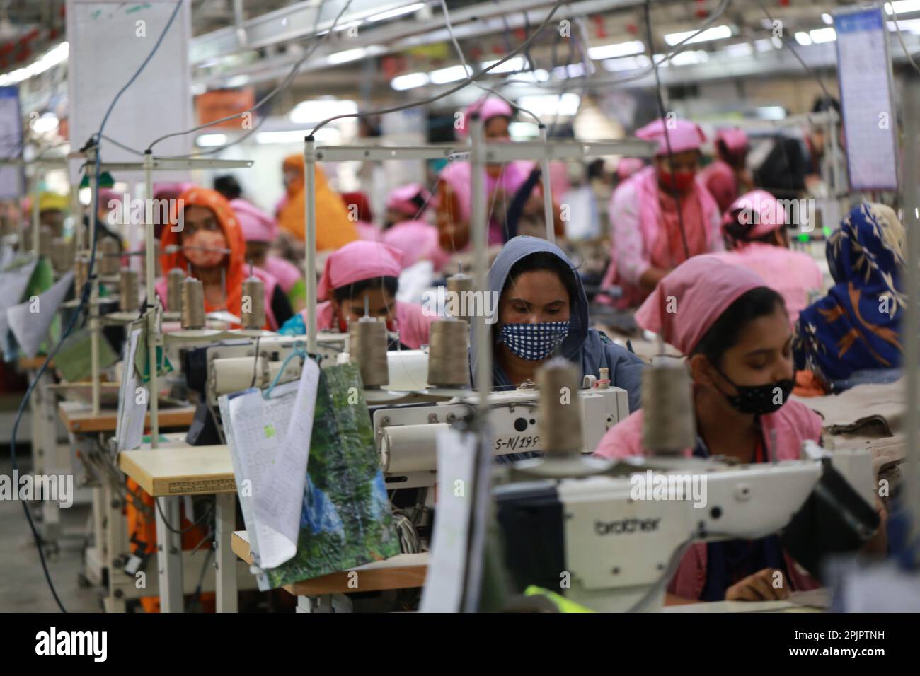 Garment workers work at a ready-made garment factory in Bangladesh ...