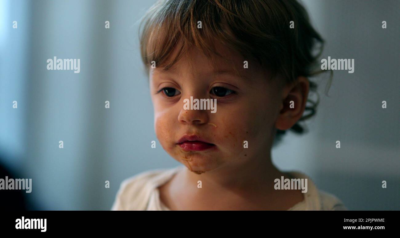 Portrait of messy baby infant child. Dirty boy made a mess after meal ...