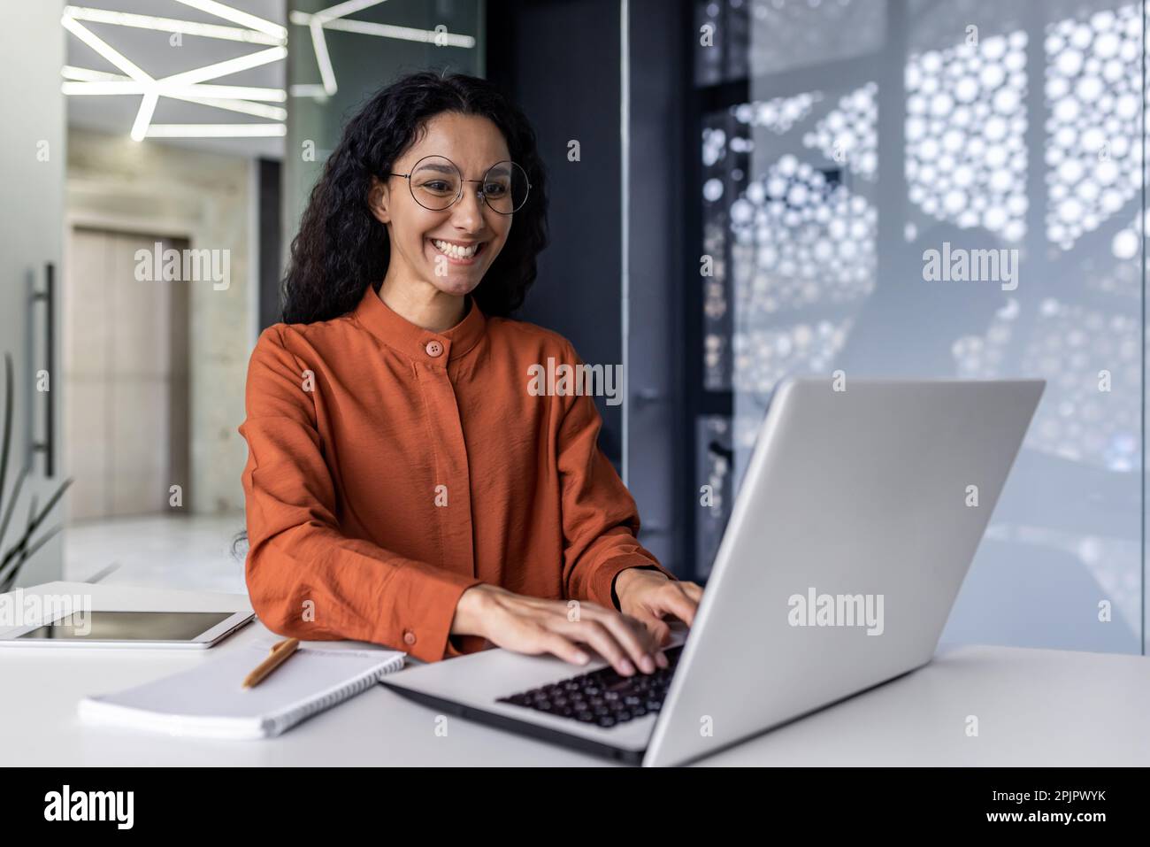 Beautiful and successful hispanic business woman inside office working ...