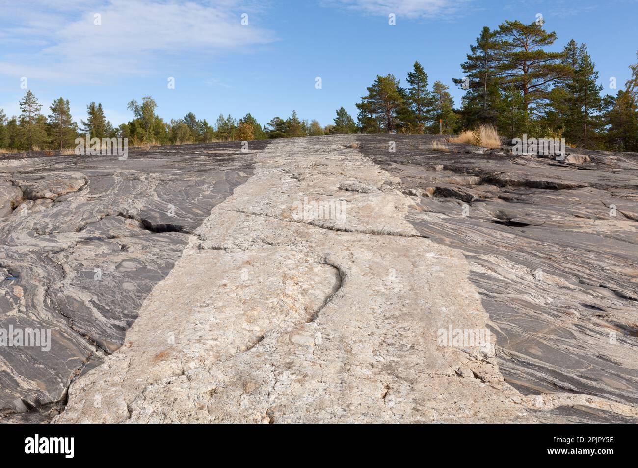 Cliffs by the sea shaped by the heavy ice sheet during the last Ice Age ...