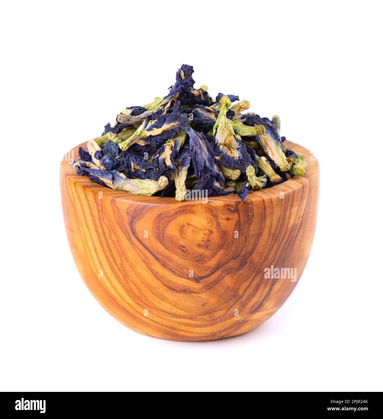 Butterfly pea flowers in wooden bowl, isolated on white background ...