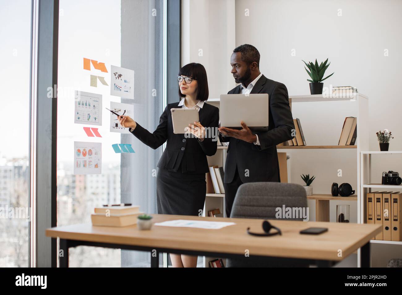 Confident entrepreneurs working together in office with help of modern ...