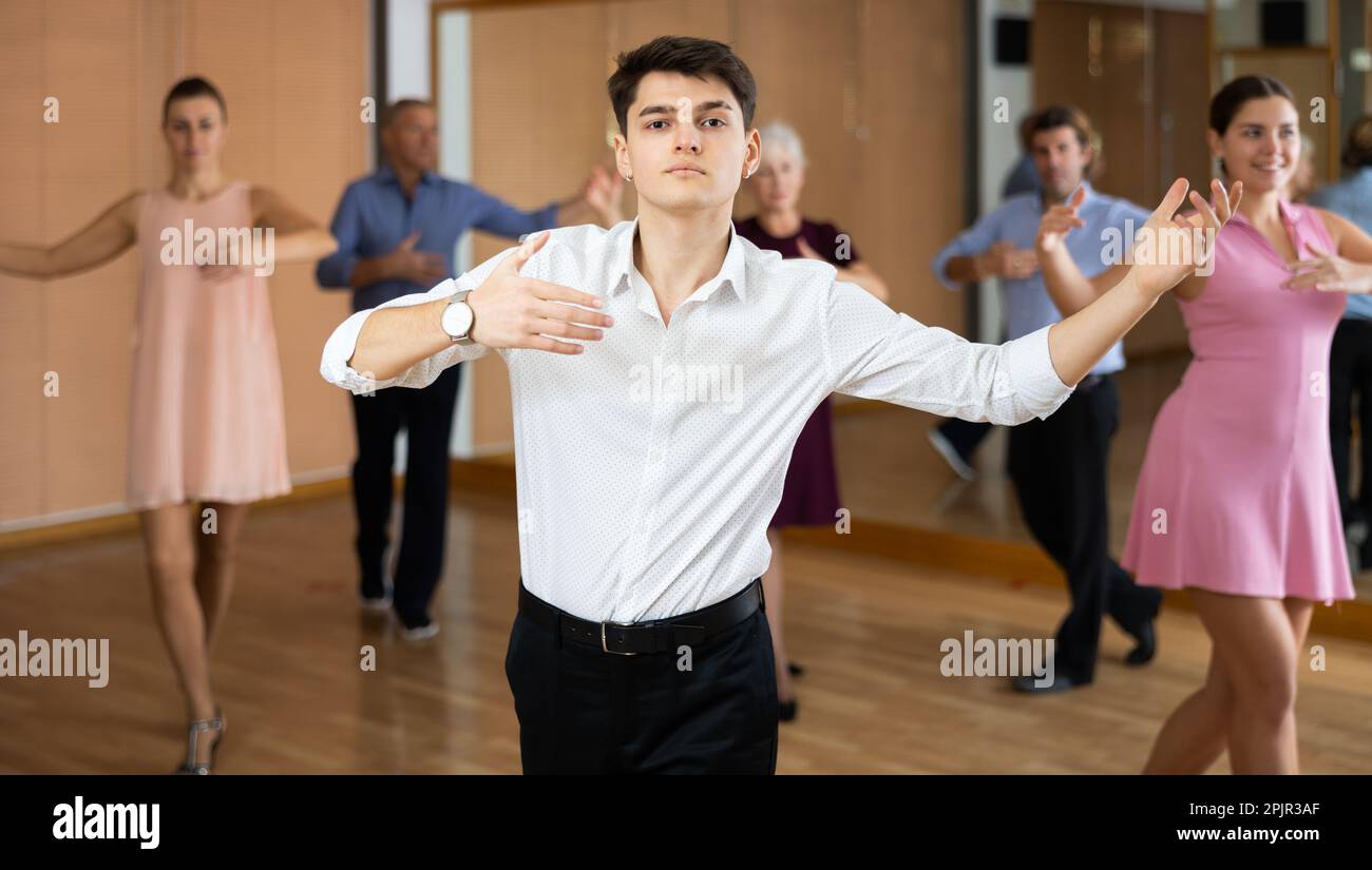 Guy practicing movements of slow dance during group class Stock Photo ...