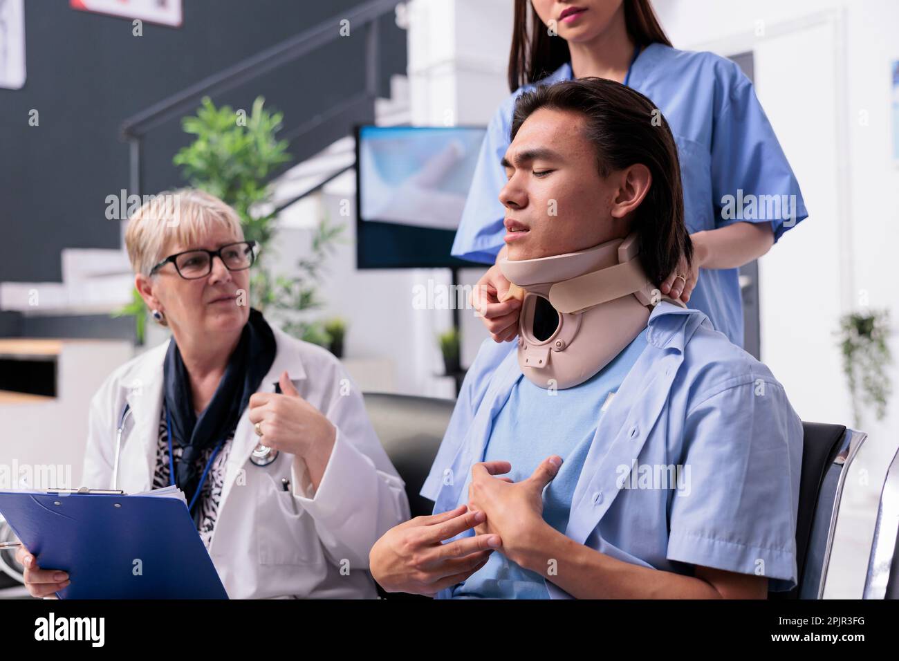 Medical staff helping asian patient with neck brace removing cervical ...
