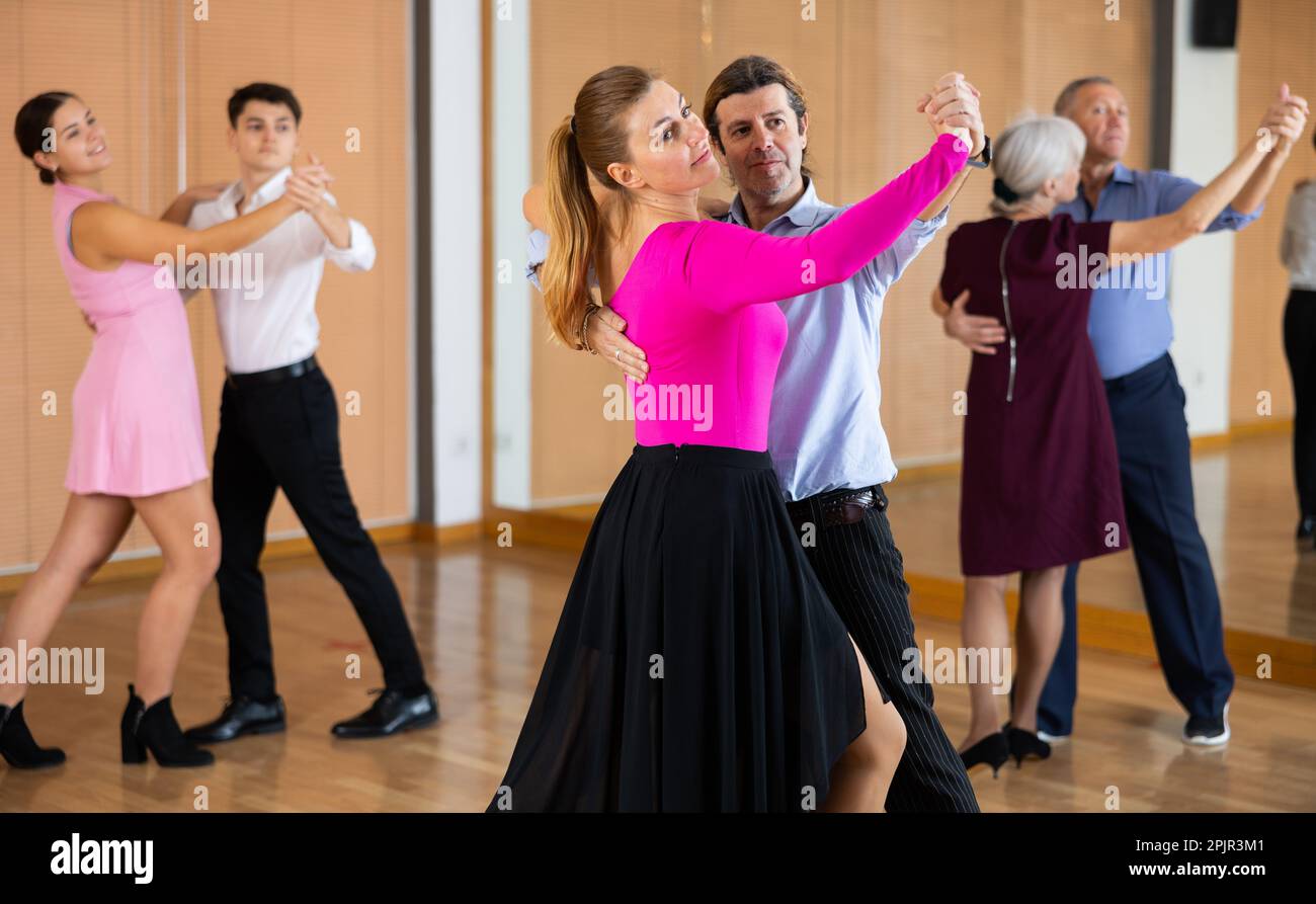Happy couple performing a paired dance in ballroom Stock Photo - Alamy