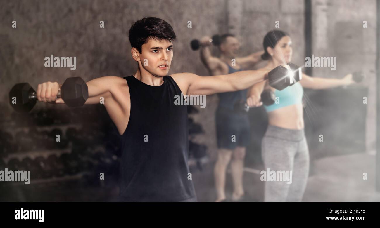 Focused guy performing arm and shoulder workout with dumbbells Stock ...