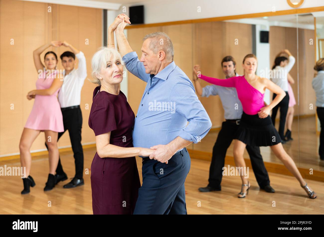 Elderly pair practicing ballroom dance in dance studio Stock Photo - Alamy