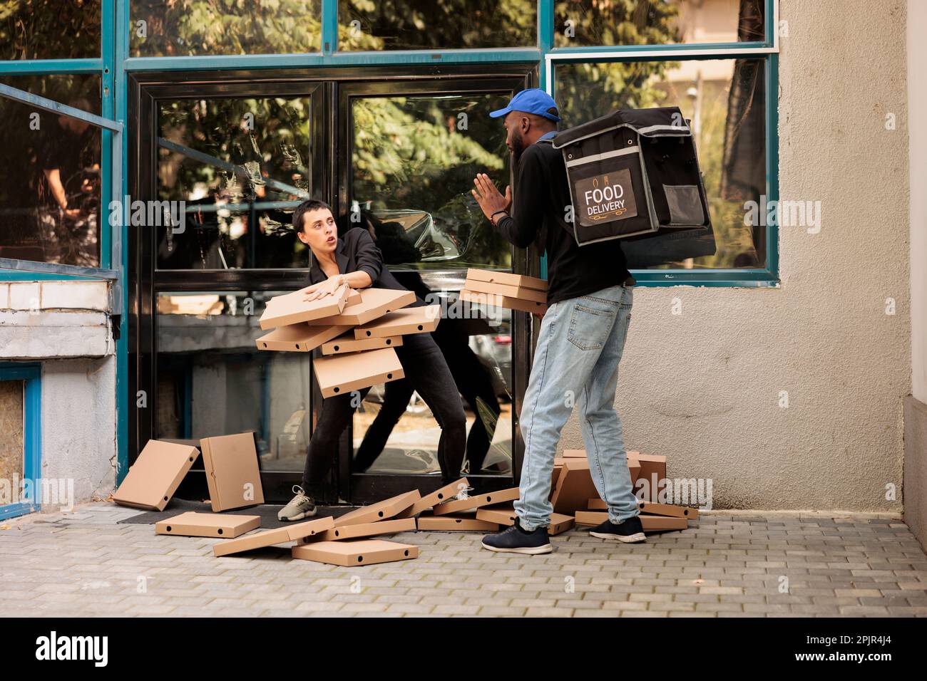 Confused woman catching falling pizza boxes stack, scared courier ...