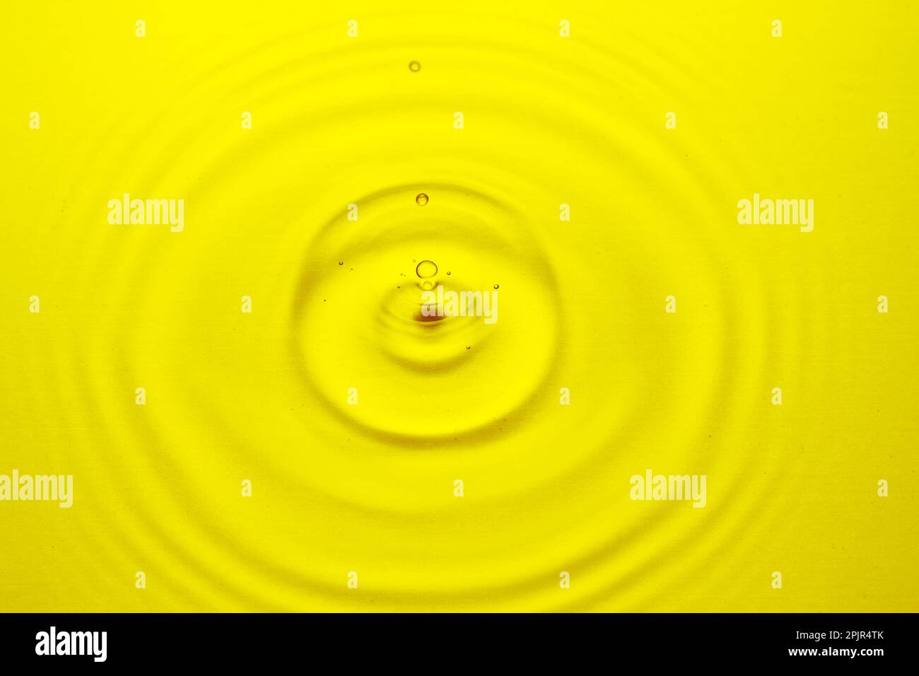 Golden water ripple and water drop Stock Photo - Alamy