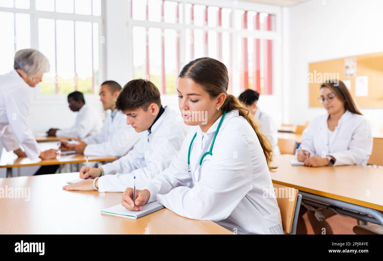 Girl medical student listening to lecture in classroom Stock Photo - Alamy