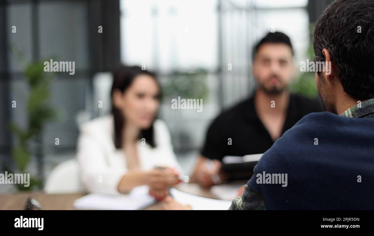 business people sitting at the table talking back view Stock Photo - Alamy
