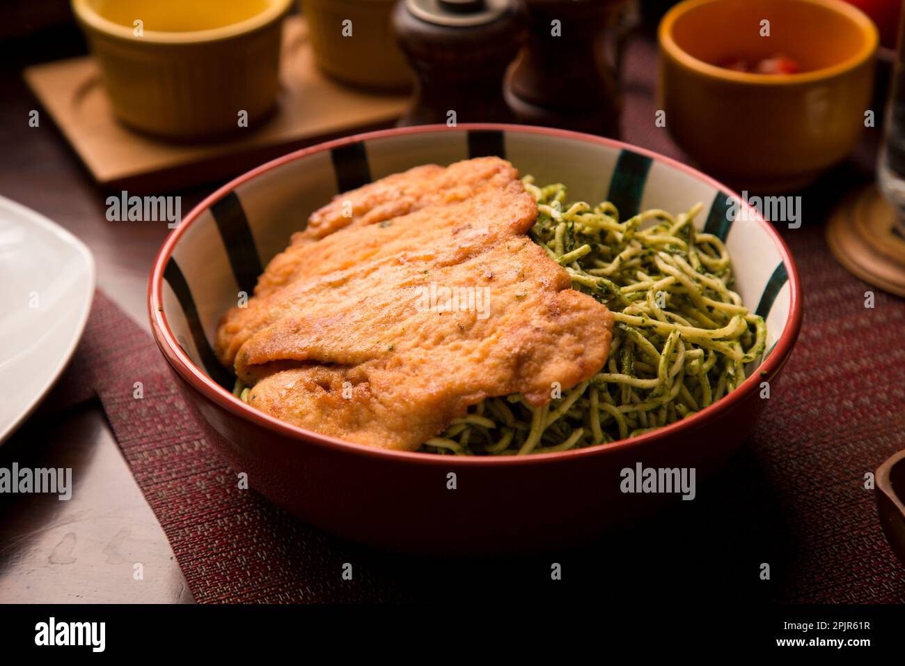 Green pasta with fried chicken Peruvian food buffet table Assorted ...