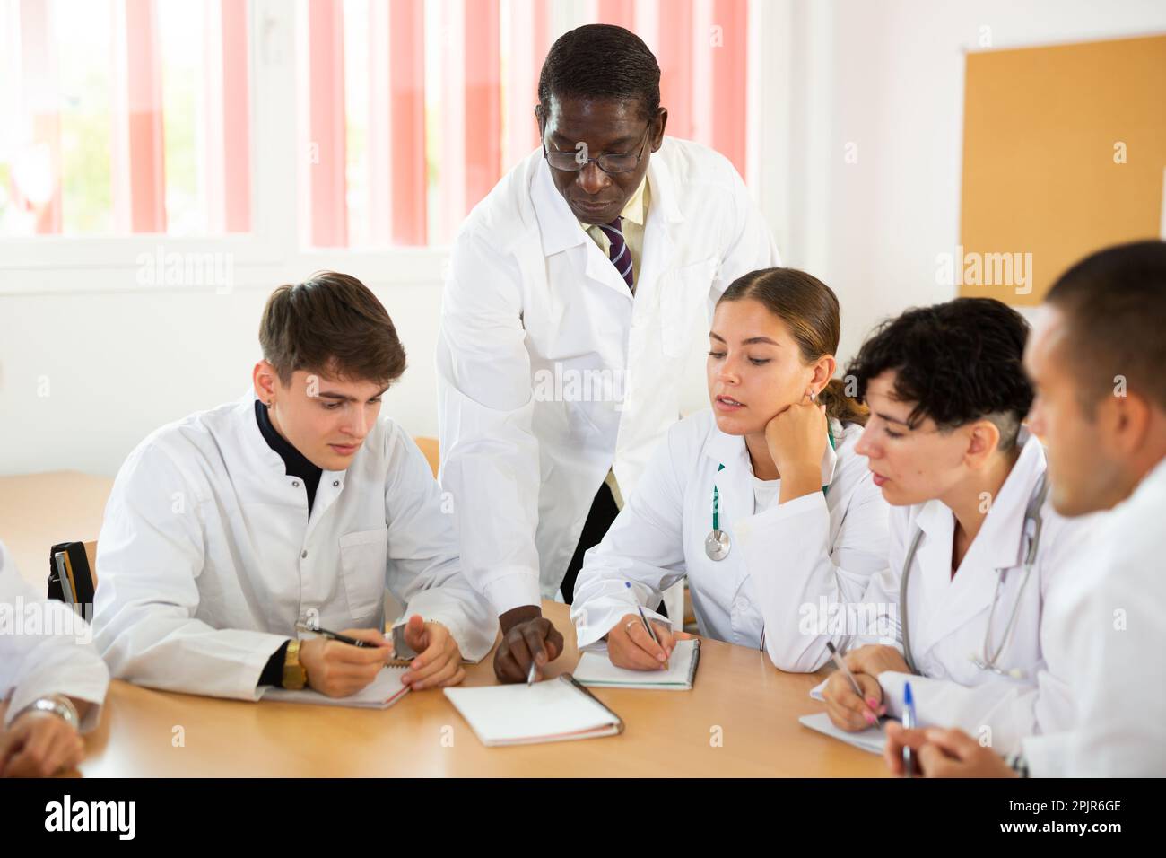 Professor explaining subject to group of medical students Stock Photo ...