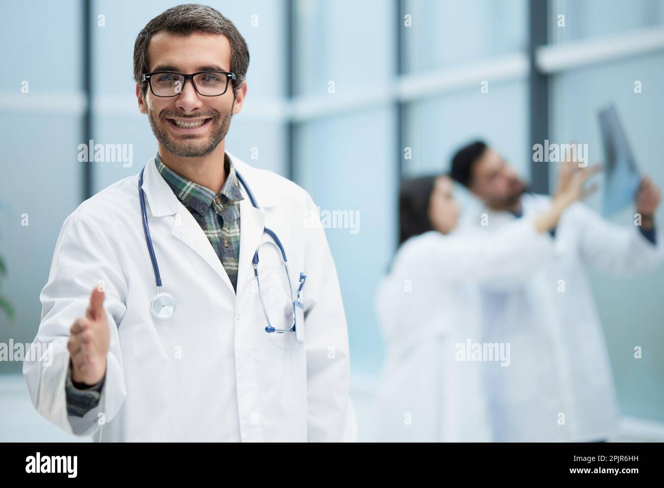 image of the doctor holding out his hand for greeting Stock Photo - Alamy